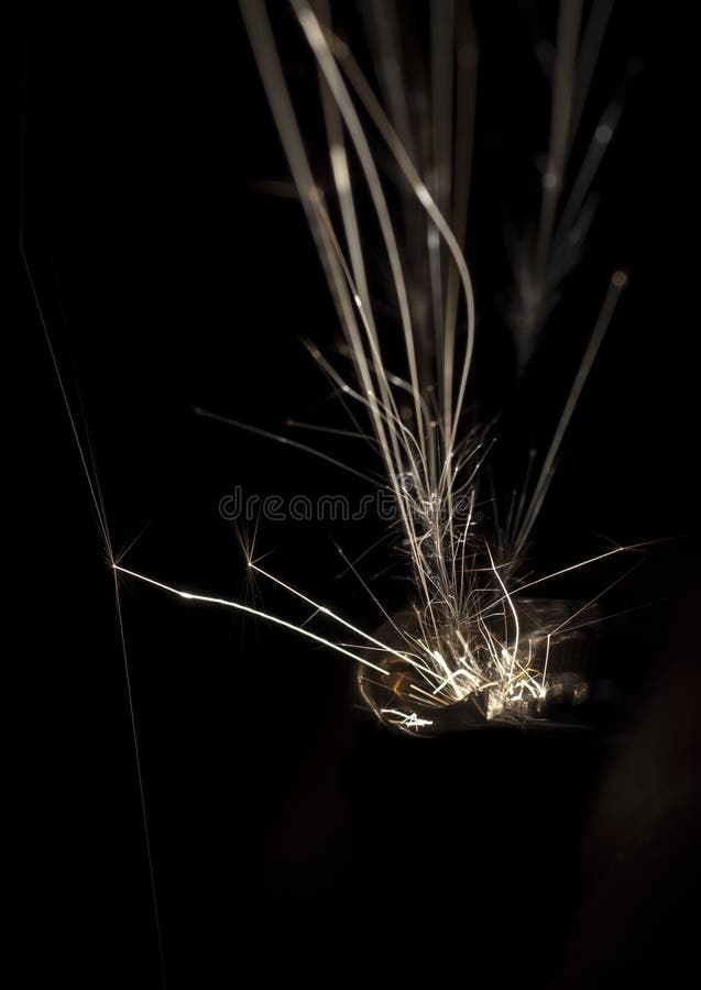 Horizontal Sparks Fly from Lighter in Dark Environment with Black ...