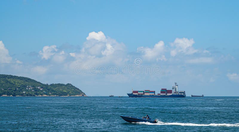 Horizontal View of Sea with a Container Ship and a Speedboat Under the ...
