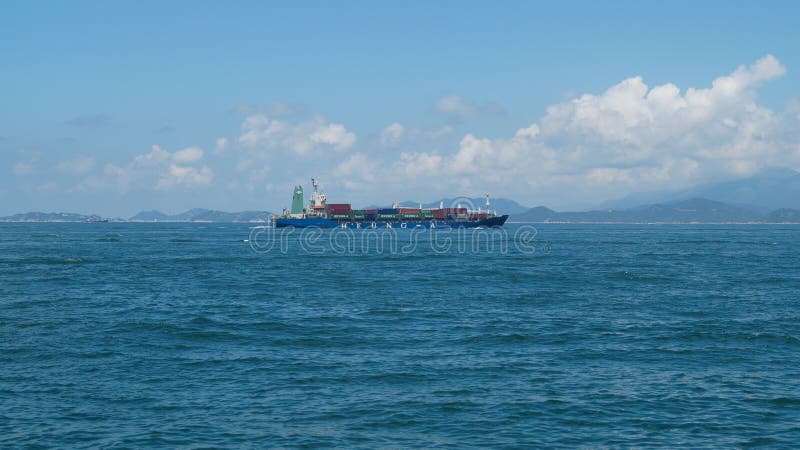 Horizontal View of Sea with a Container Ship Under the Blue Sky ...
