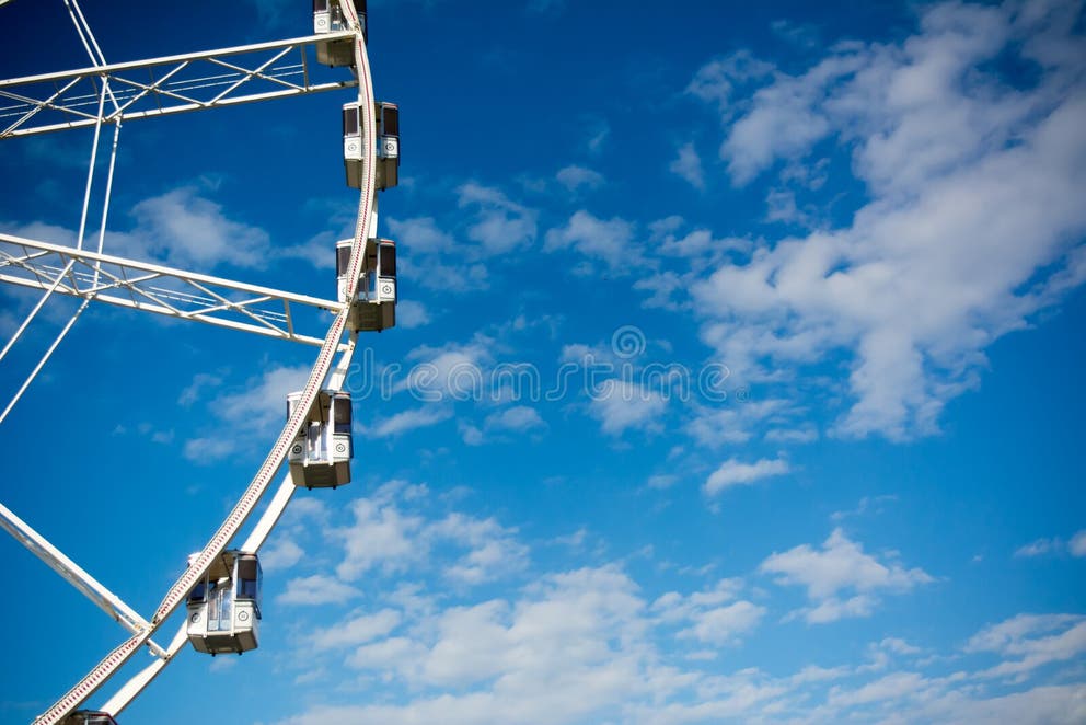 Horizontal View of a White Ferris Wheel on Partially Cloudy Sky Stock ...