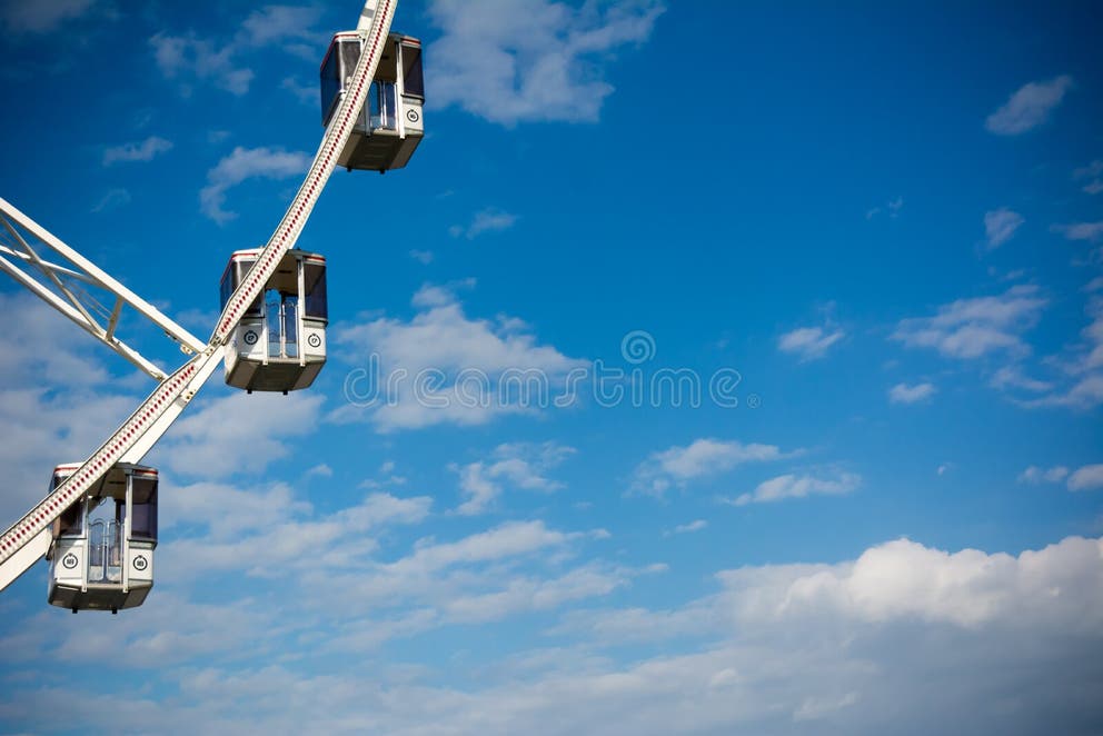 Horizontal View of a White Ferris Wheel on Partially Cloudy Sky Stock ...