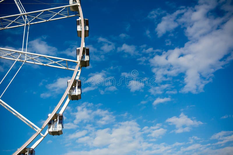 Horizontal View of a White Ferris Wheel on Partially Cloudy Sky Stock ...