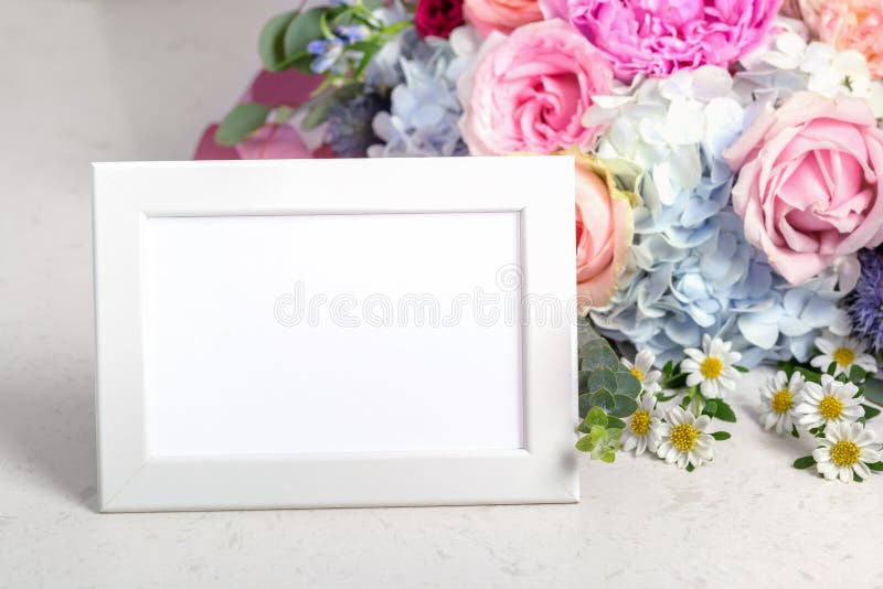 Horizontal White Photo Frame with Flower Bouquet on Marble Table Stock ...