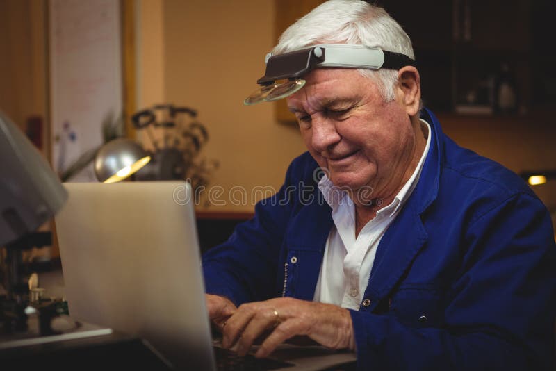 Smiling Horologist Examining Clock Parts in Workshop Stock Photo ...