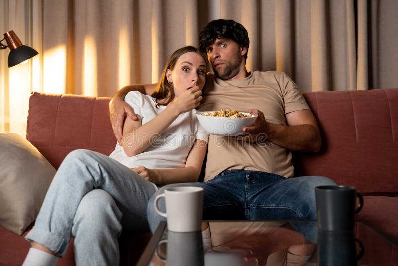 Horror Movie Shocked Couple Watching Scary Film On Tv And Eating