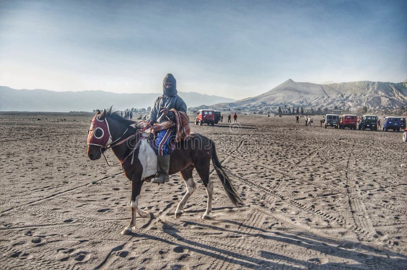 Horse rider in java desert editorial stock photo. Image of java - 173020663