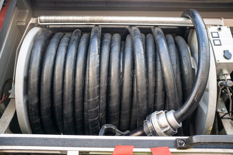 Hose Needed To Put Out the Fire is Rolled Up in the Fire Engine. Stock ...