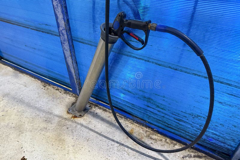 A Hose with Water for Washing a Car Stock Photo - Image of selfwash ...