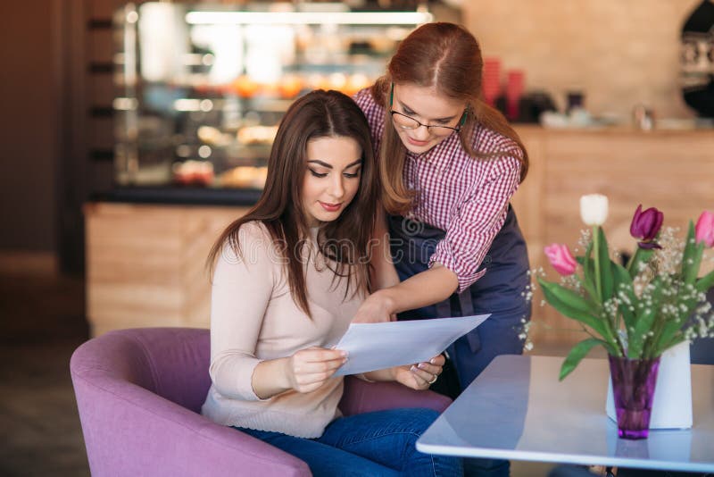 Hospitable Waitress Help To Customer What To Choose Something from Menu ...