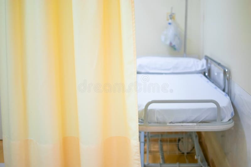 Hospital Bed or Stretcher with Light Yellow Curtain As Copy Space Stock ...