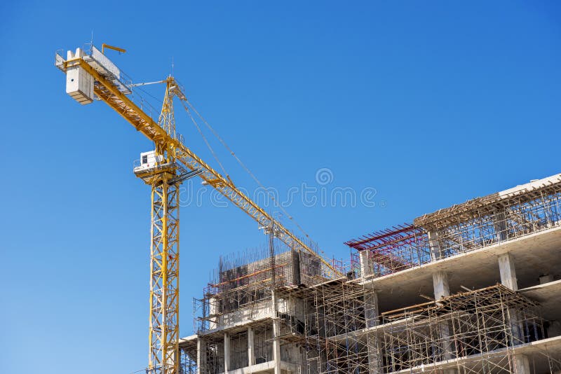 Hospital Building Under Construction with Cranes Against a Blue Sky ...