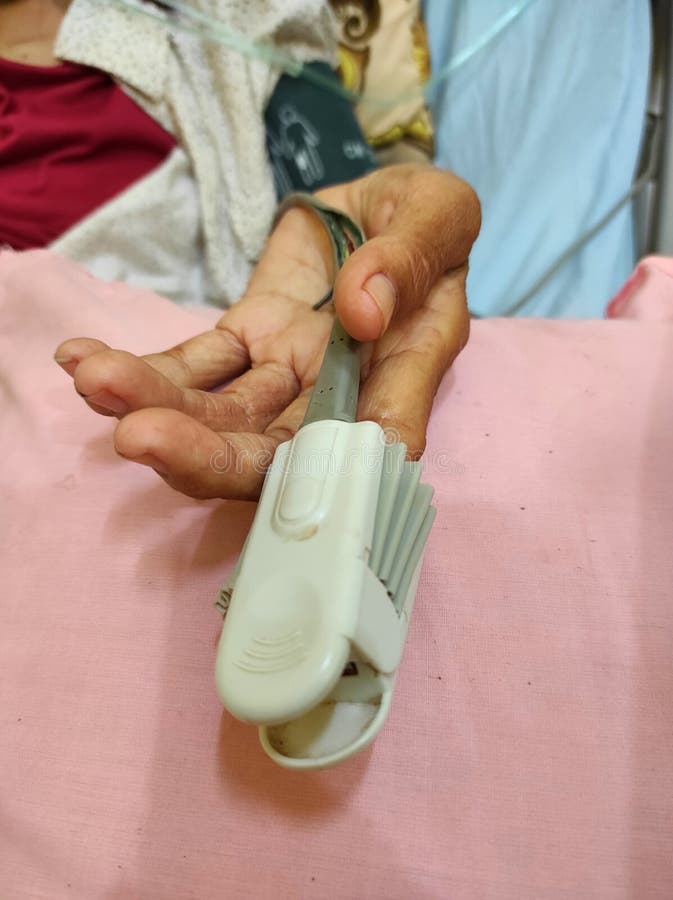 A Hospital Patient Whose Hand is Using a Health Check Tool Stock Photo ...