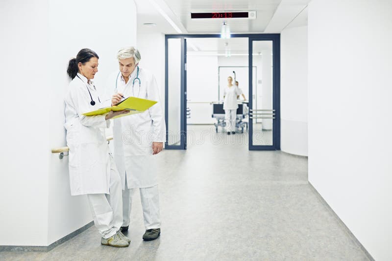 Two doctors in discussion stock image. Image of advice - 4729143