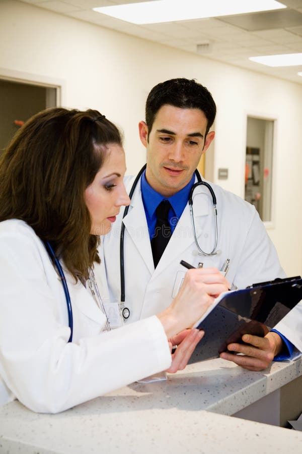 Hospital: Two Doctors Discussing Test Results Stock Photo - Image of ...
