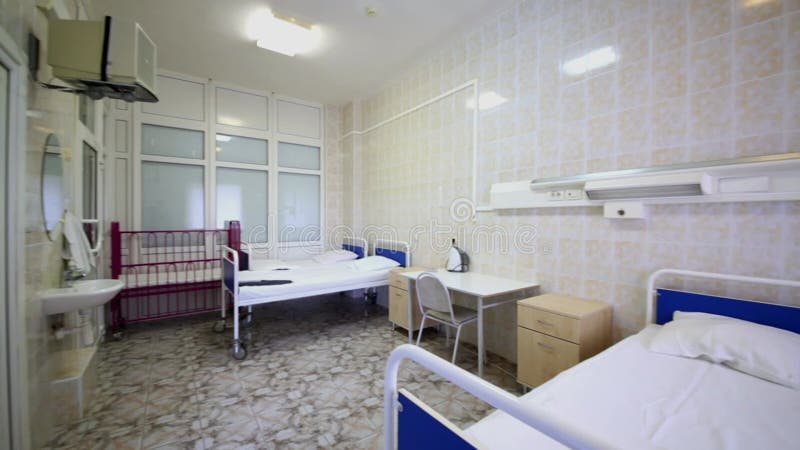 Hospital Ward with Five Beds, Table and Washing Stock Footage - Video ...