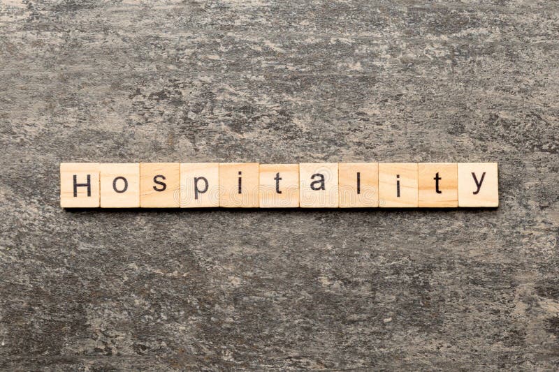 Hospitality Word Written on Wood Block. Hospitality Text on Table ...