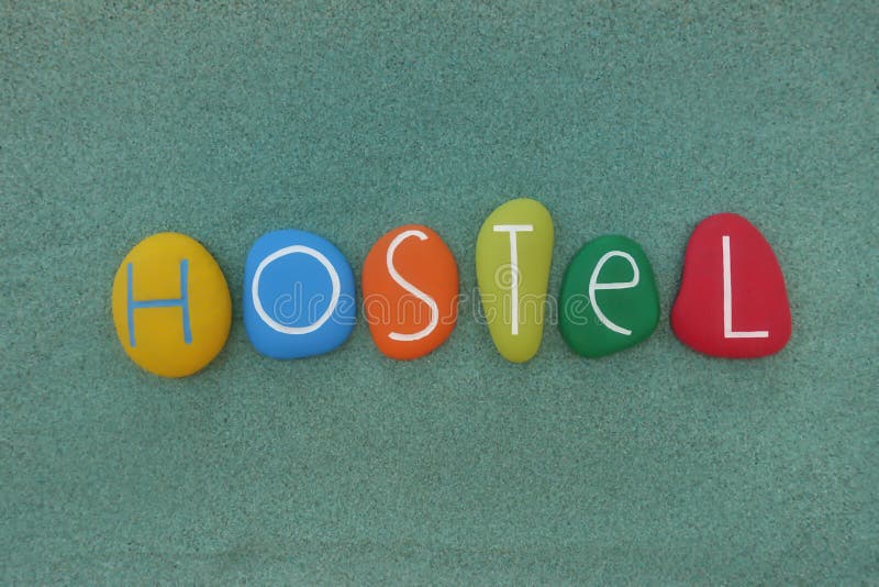 Hostel Text Composed with Colored Stones Over Green Sand Stock Photo ...