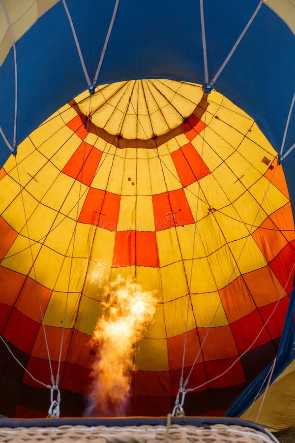 A Hot Air Balloon with a Fire in the Bottom of it Stock Photo - Image ...