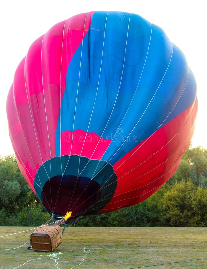 A Hot Air Balloon is in the Air with a Fire Burning Inside Stock Image ...