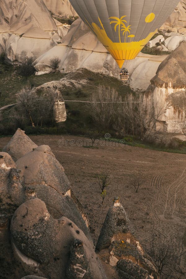 A Hot Air Balloon Flying into a Valley of Rocks Stock Image - Image of ...