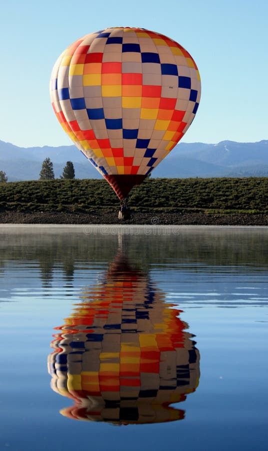 Hot air balloon over lake stock image. Image of water - 15432711