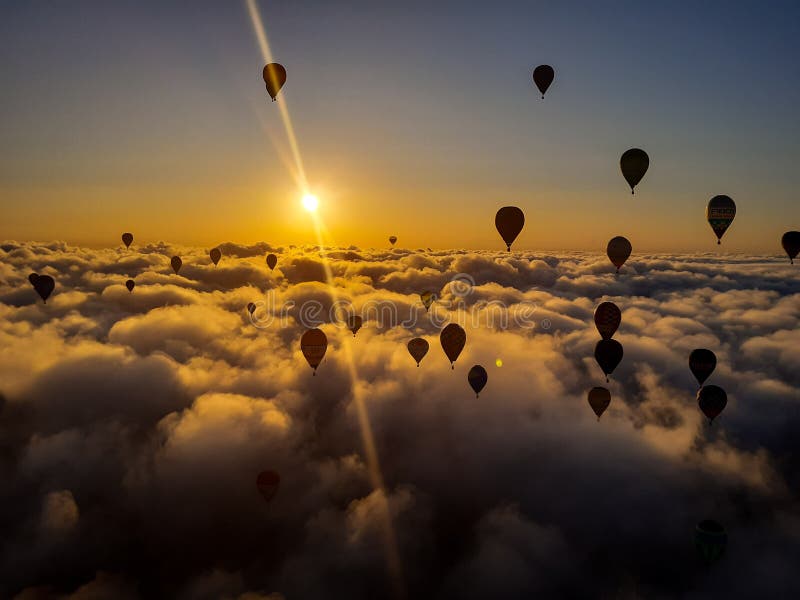 Hot Air Balloons Over Clouds at Sunrise Stock Image - Image of clouds ...