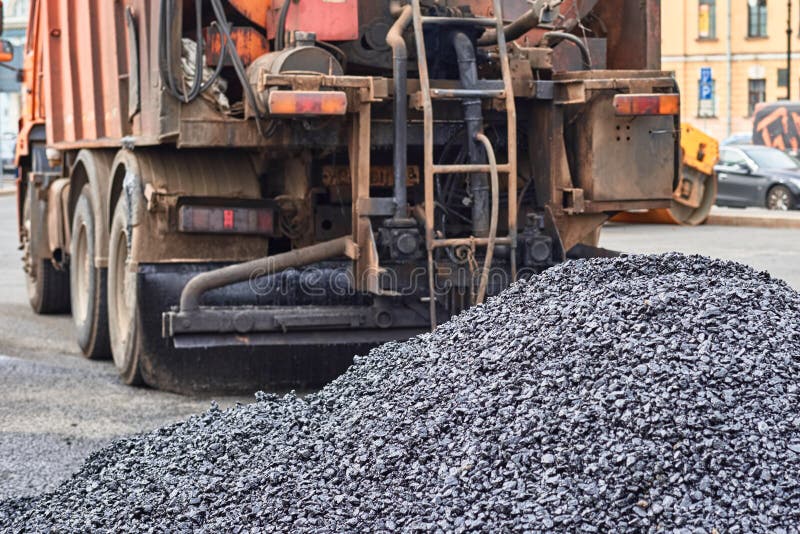 Hot Asphalt and Trick with a Bitumen in City. Road Construction Stock ...