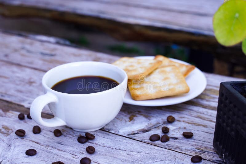 The Hot Black Coffee in a White Cup and the Crackers. Stock Image ...