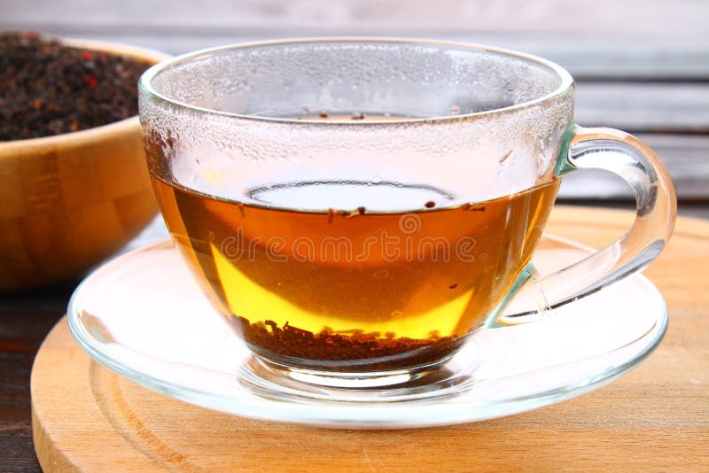 Hot Black Tea in a Glass Cup and Dry Tea on a Wooden Table. Stock Photo ...
