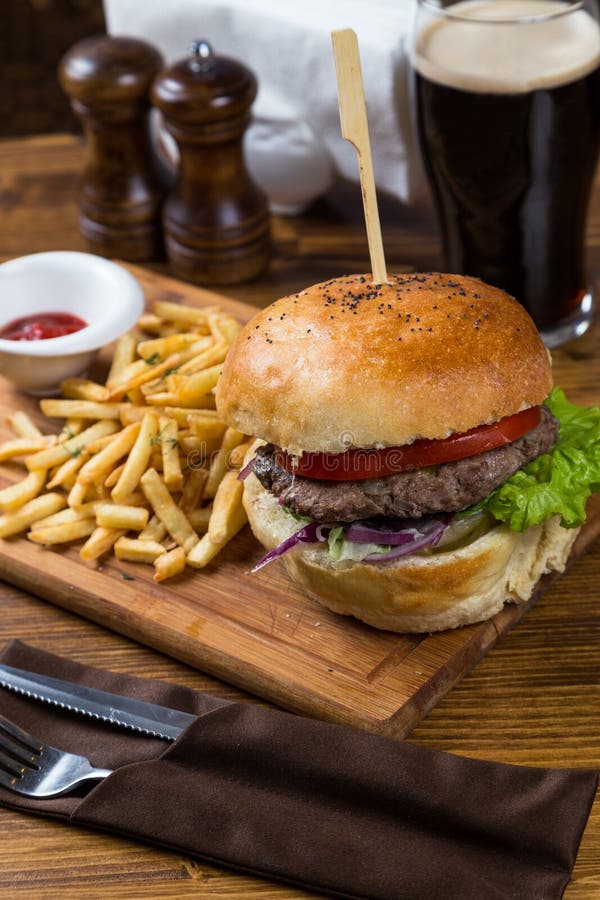 Hot Burger Serving on Wooden Board with Dark Beer Stock Image - Image ...