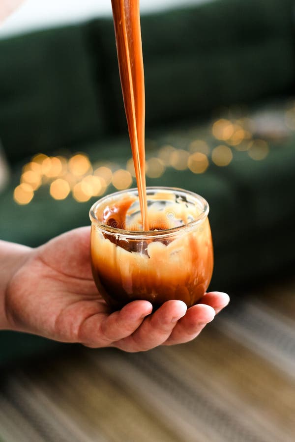 Melted Caramel in a Glass in Hand, in a Cozy Setting Stock Photo ...