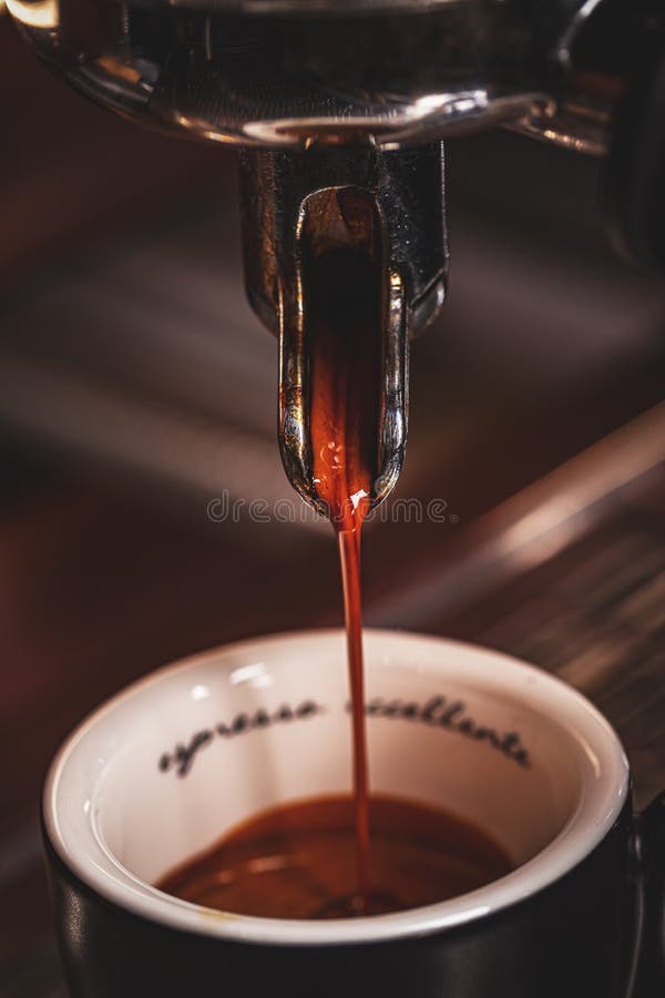 Hot coffee flow to a cup stock image. Image of machine - 164549761