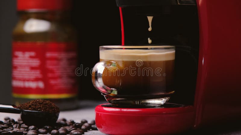 Hot Coffee Flows into a Cup with an Espresso Machine, Close-up. Modern ...