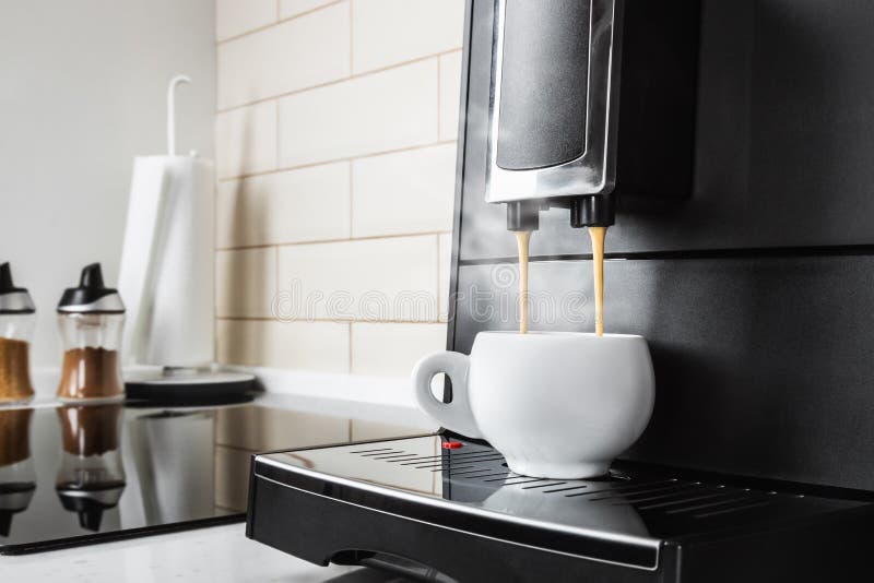 Hot Coffee from the Coffee Machine is Poured Stock Image - Image of ...