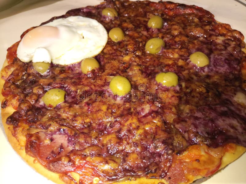 Crispy Cooked Pizza with a Fried Egg and Green Stock Photo - Image of ...