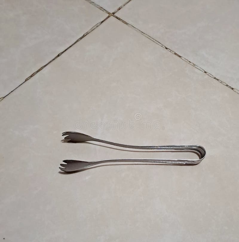 Hot Cooking Tongs for Mom in the Kitchen. Stock Photo - Image of metal ...