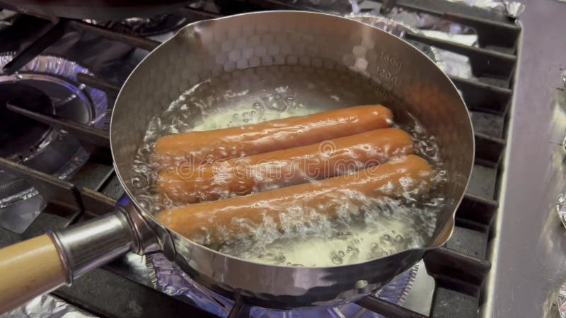 Hot dog boiling at water stock video. Video of heat - 280544239