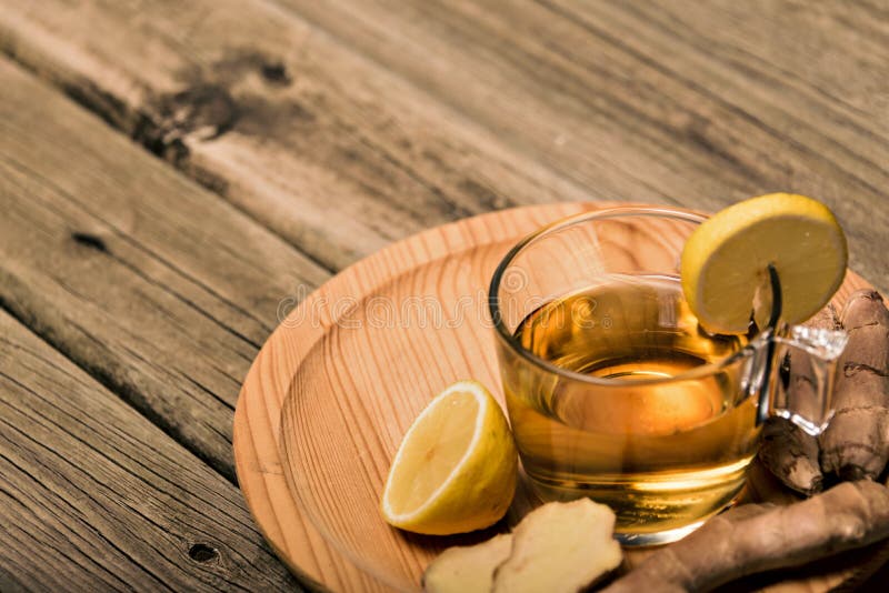 Hot Ginger-infused Cup on a White Table with Sliced Ginger Root in a ...