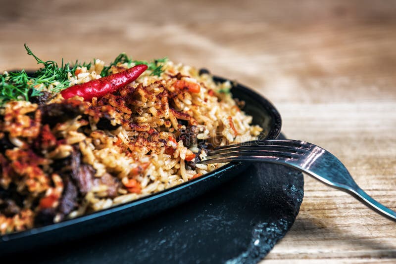 Hot pan with pilaf stock photo. Image of knife, garlic - 168611122