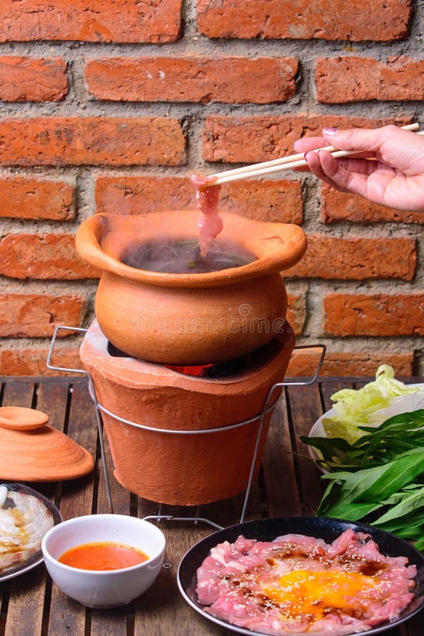 Hot Pot with Clear Soup in the Clay Cooking Pot. Stock Photo - Image of ...