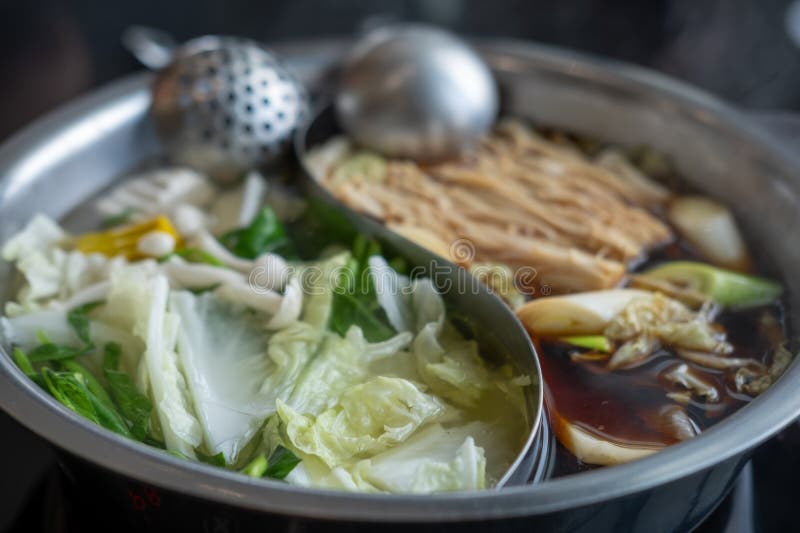Hot Pot with Two Types of Soup, Clear and Shabu Soup. Stock Image ...