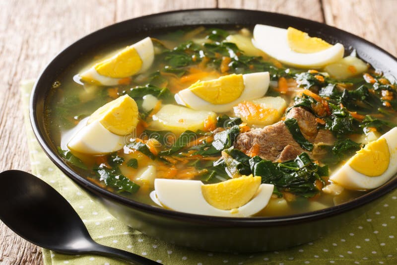 Hot Rich Soup with Meat, Spinach, Vegetables and Eggs Close-up in a ...