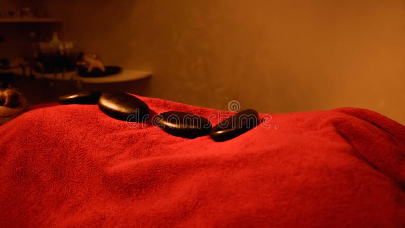 Hot Stones on Back of Client Stock Photo - Image of towel, beauty ...