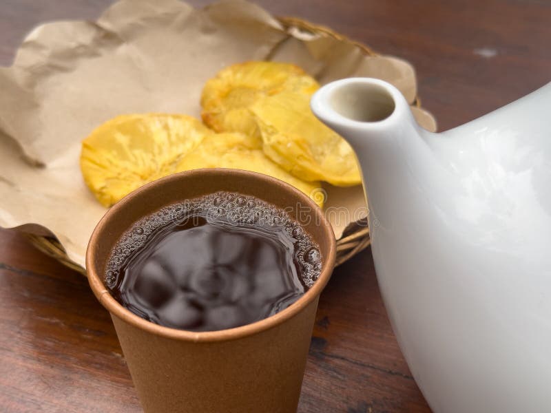 Hot Tea Brewed from a Teapot with a View of a Plate of Fried Breadfruit ...