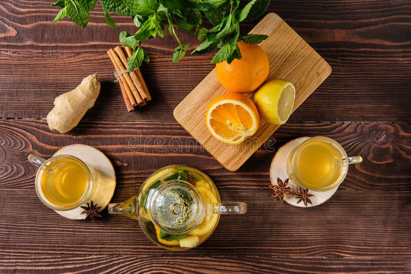 Hot Tea with Lemon, Orange, Ginger and Mint on Wooden Table in the ...