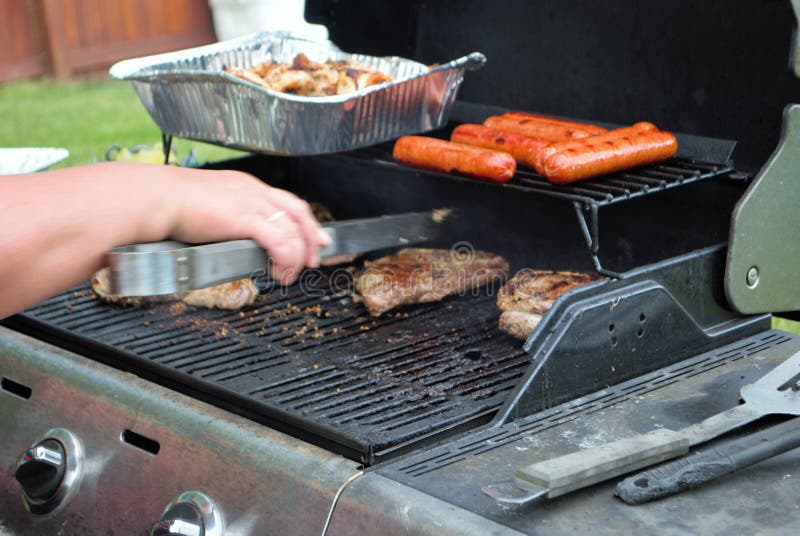 Hotdogs and Steak on the Grill at a Backyard Cookout Stock Photo ...
