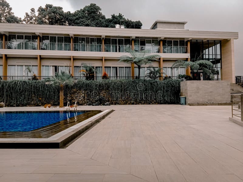 Hotel building with pool stock photo. Image of property - 343940852