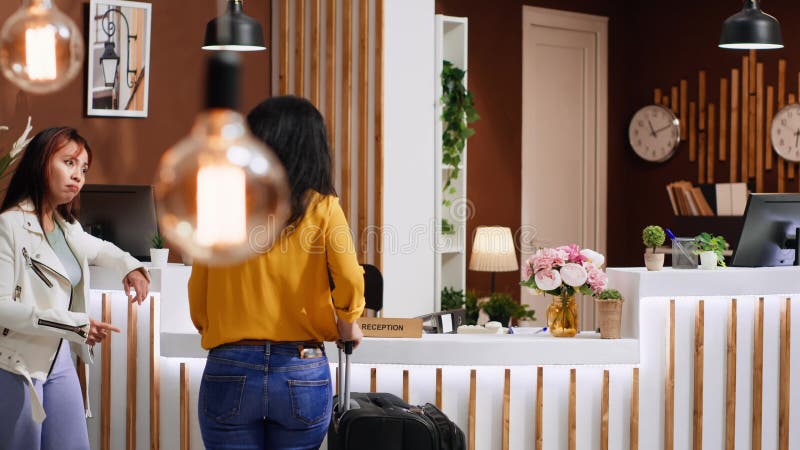 Hotel Guests Using Service Bell for Assistance at Front Desk Stock ...