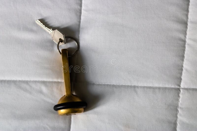 Hotel Key Laying on the White Bed Sheets Closeup Stock Image - Image of ...
