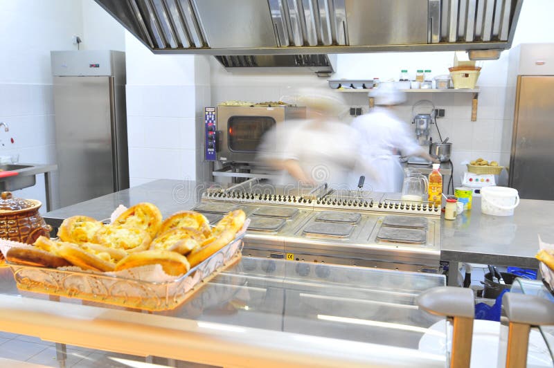 Chefs in a Restaurant or Hotel Kitchen Cooking Stock Photo - Image of ...